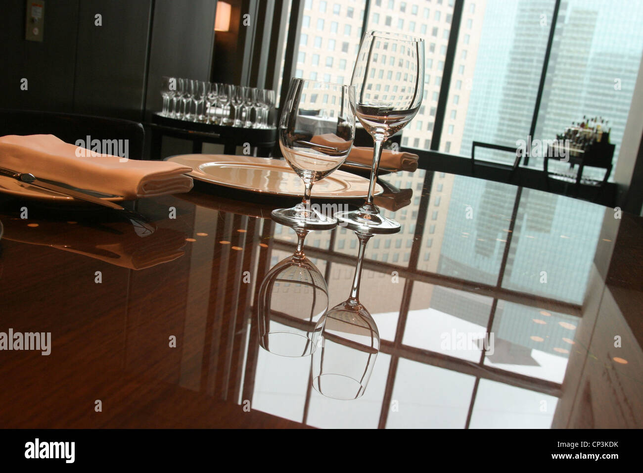 Glasses and window reflected on highly polished dining table in the ...