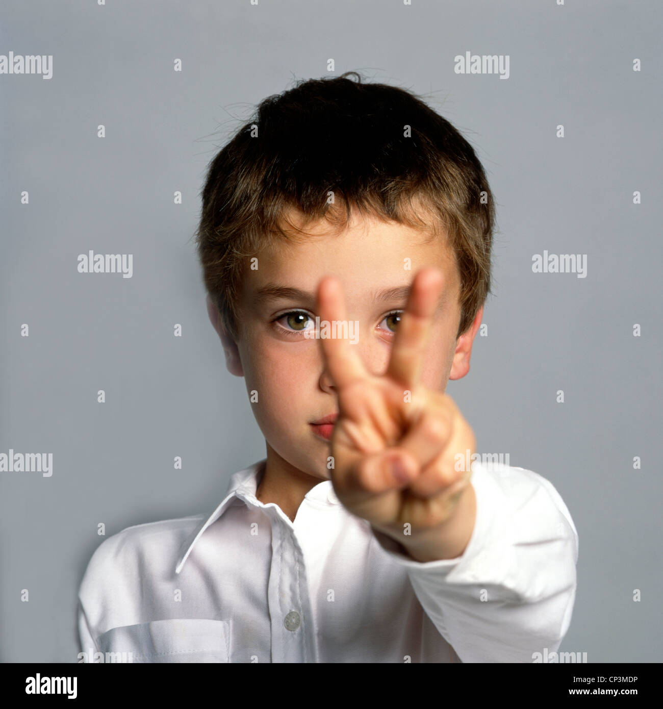 Boy Making Peace Sign Stock Photo - Alamy