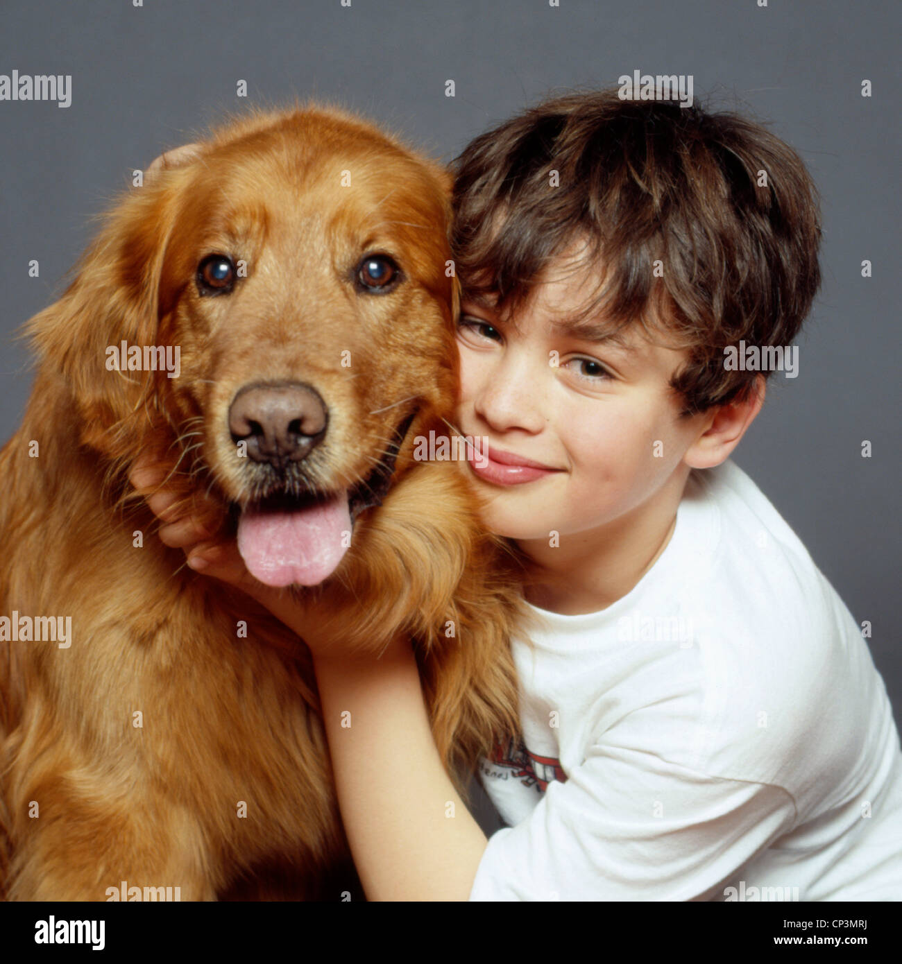 Boy Hugging Golden Retriever Stock Photo - Alamy