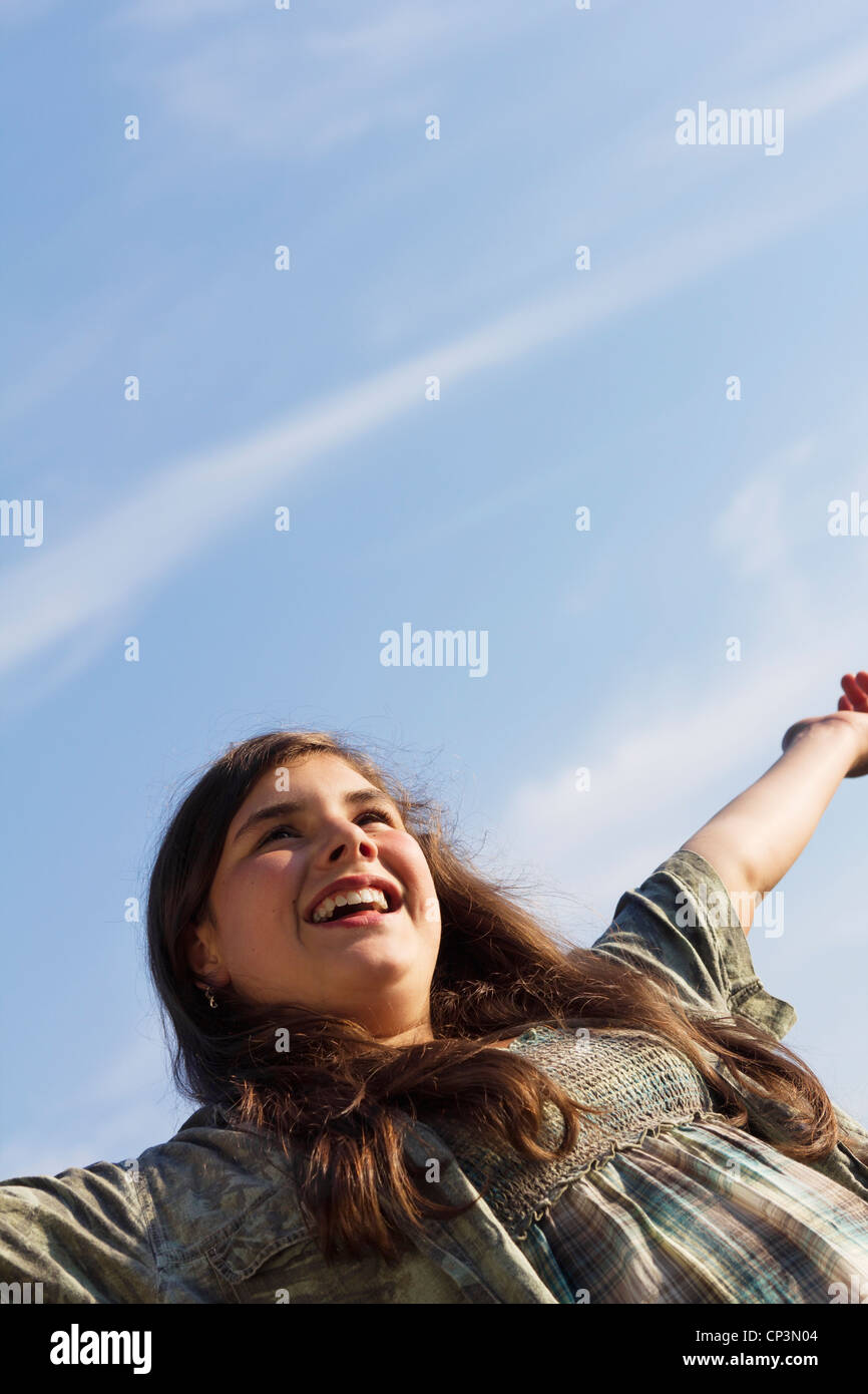 Feeling free - happy young teenage girl with opened arms having fun in ...