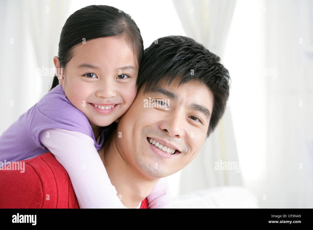 Chinese daughter embracing father from behind Stock Photo - Alamy