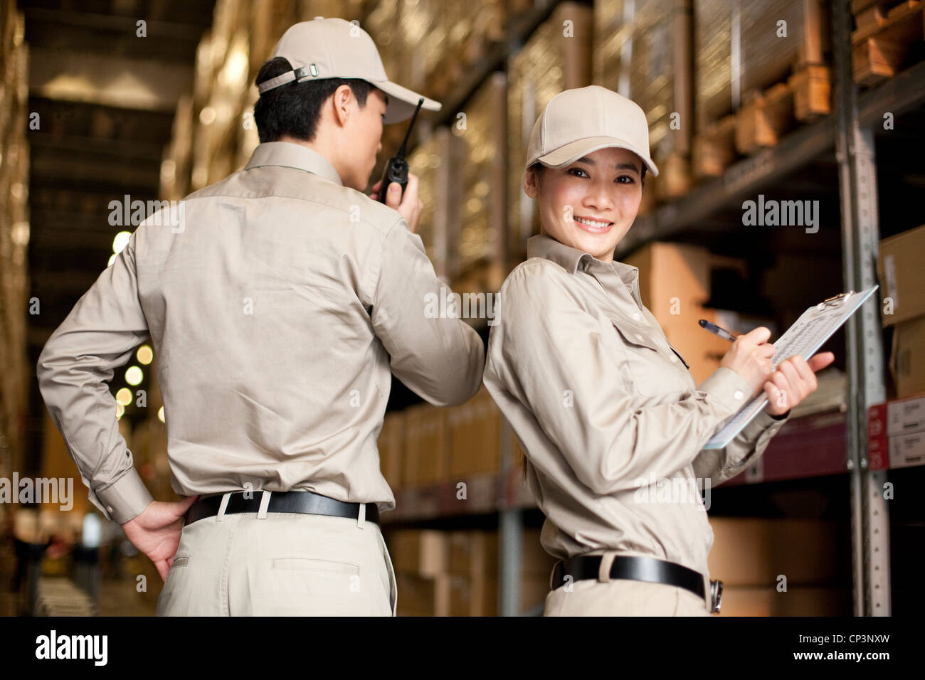 Male and female Chinese warehouse workers Stock Photo - Alamy