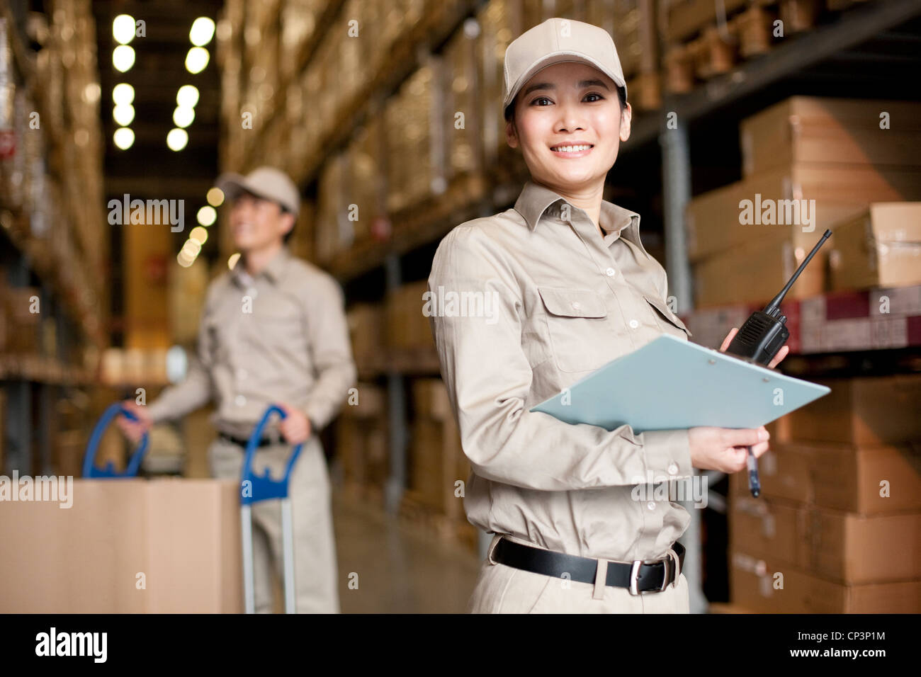 Male and female Chinese workers with walkie-talkie Stock Photo - Alamy