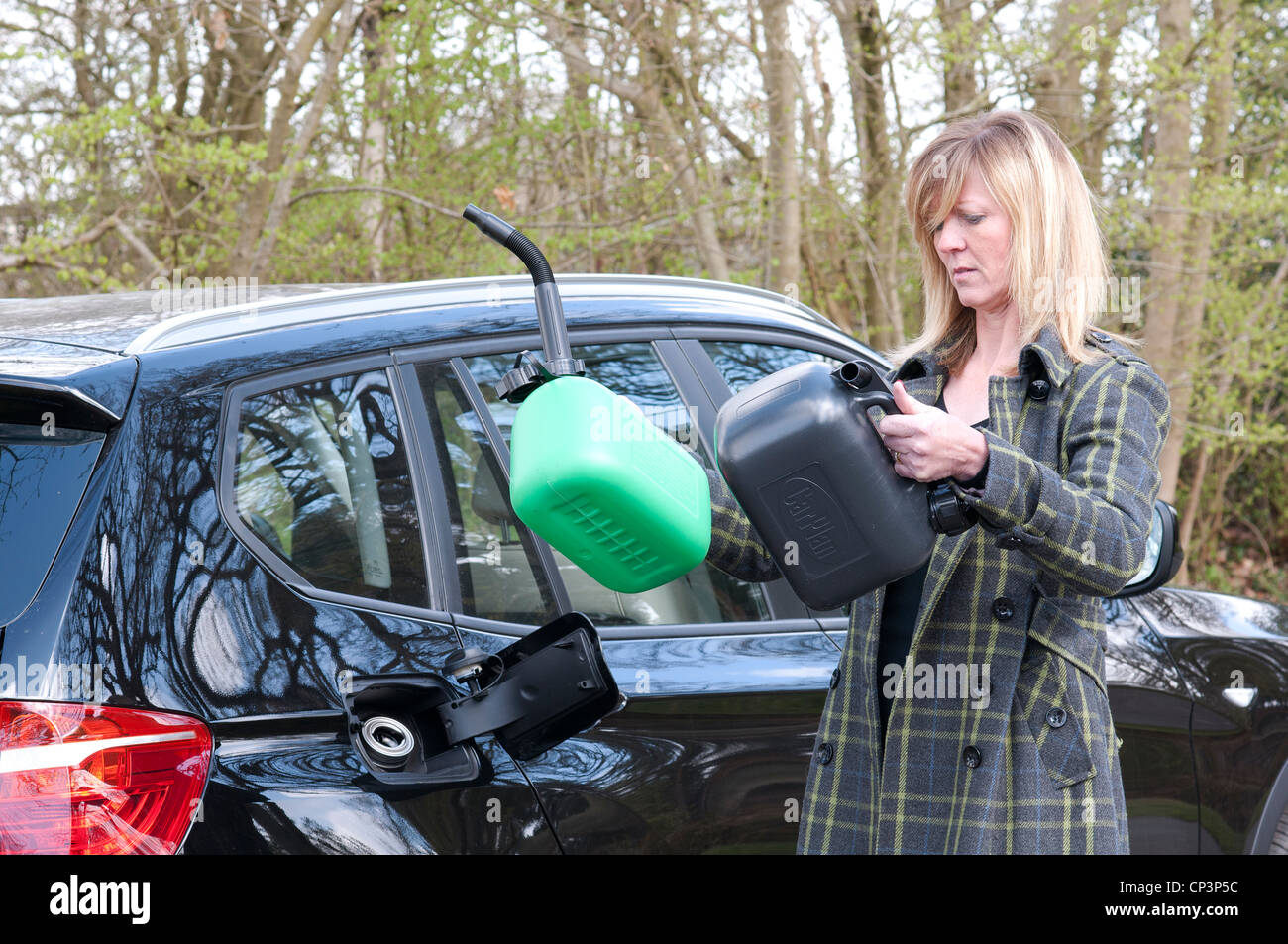 Woman driver puzzles over fuel cans the black diesel one and the green ...