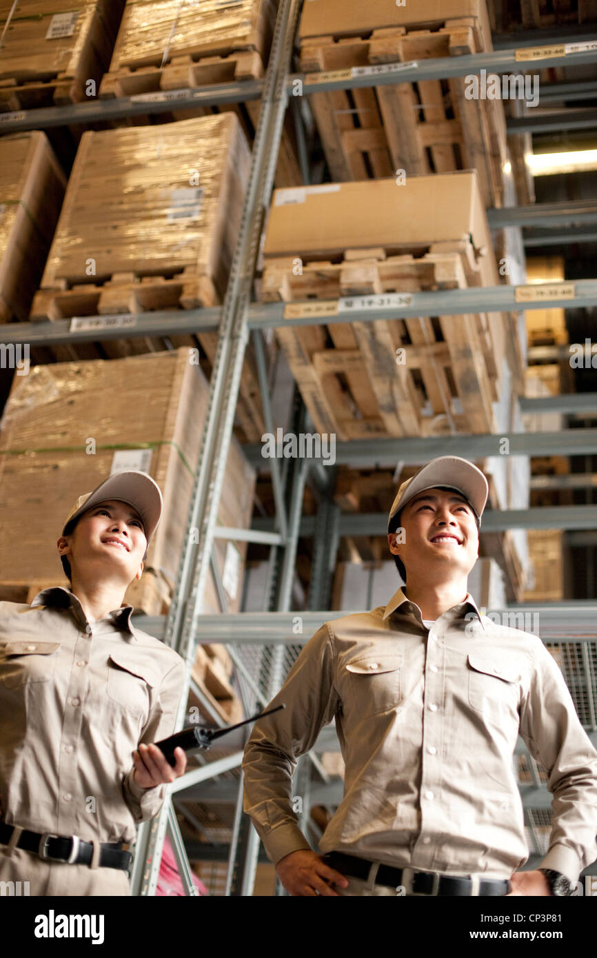 Male and female Chinese warehouse worker Stock Photo - Alamy
