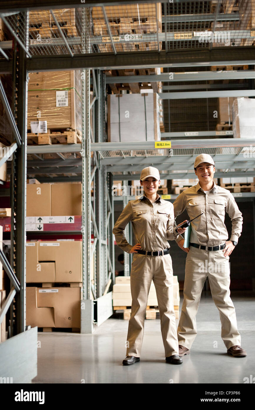 Male and female Chinese warehouse worker Stock Photo - Alamy