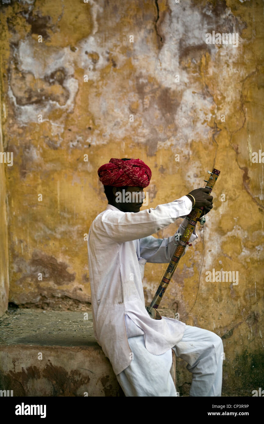 A Rajasthani gypsy musician tunes his Ravanhatta (violin) inside the ...