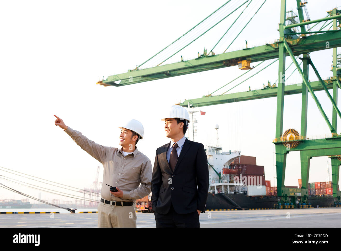 shipping industry worker showing a businessman around the port Stock ...