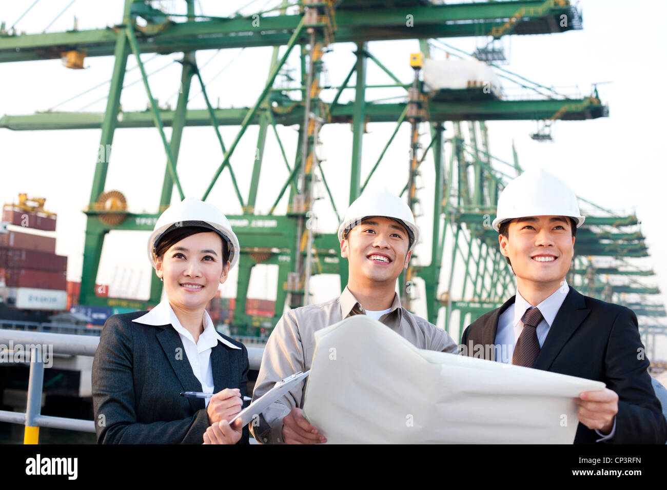 shipping industry professionals looking over blueprints in a row Stock ...