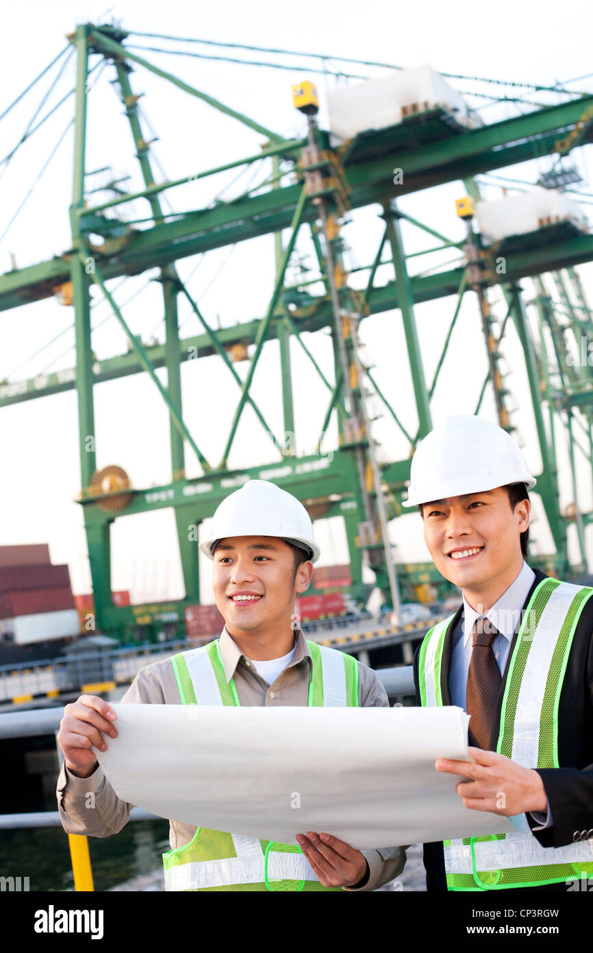 shipping industry professionals looking over blueprints Stock Photo - Alamy