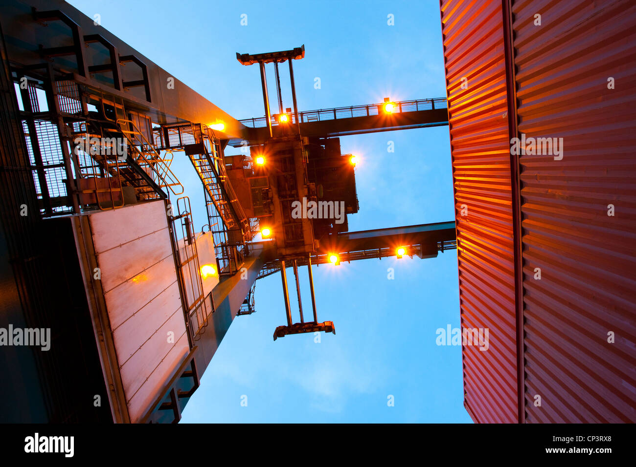 Bottom view of cranes and stack of cargo containers Stock Photo - Alamy