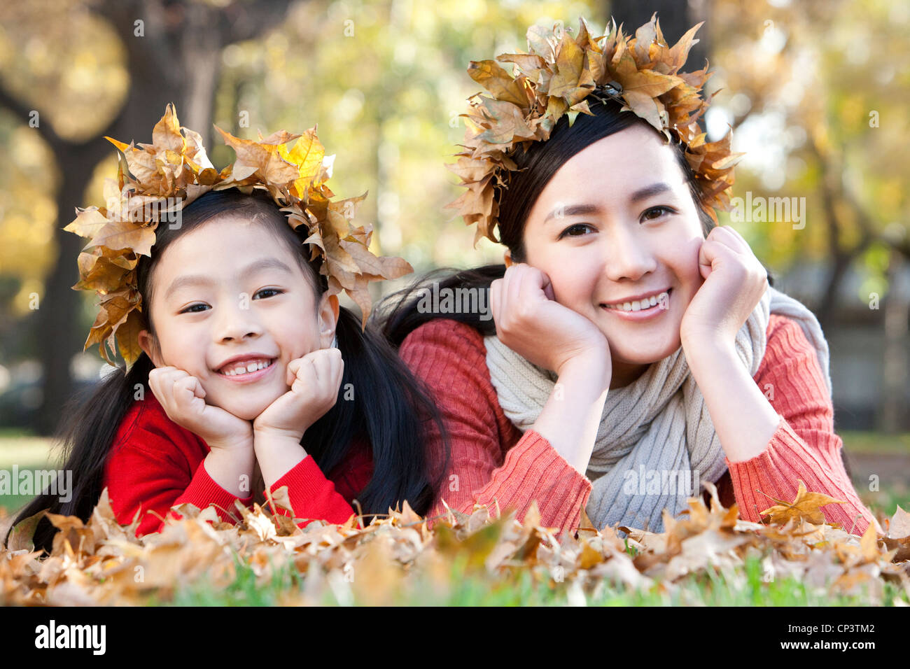 Mother and daughter with a crown of Autumn leaves Stock Photo - Alamy