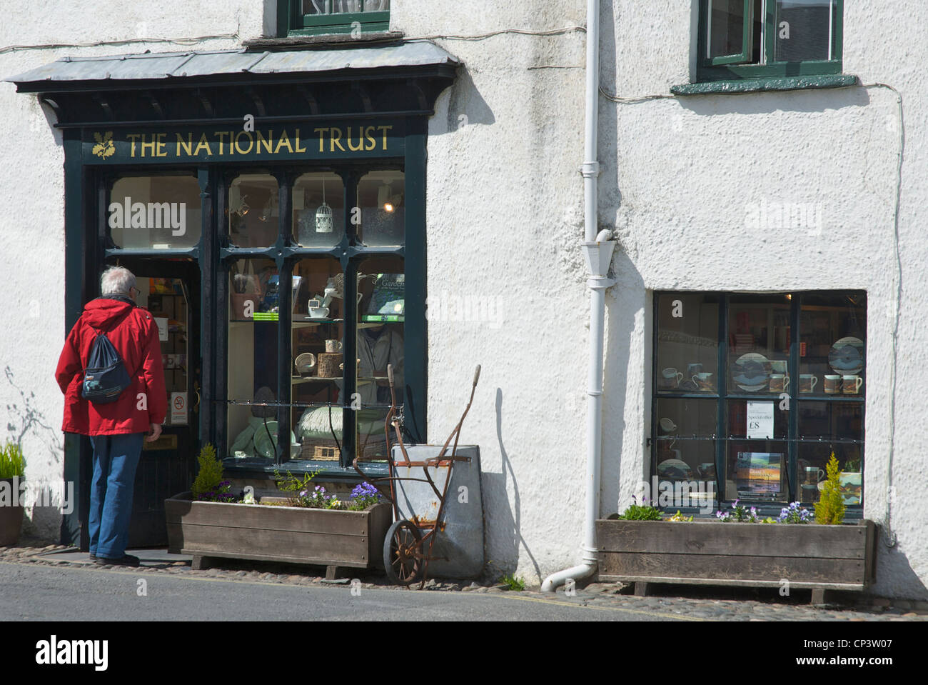 Man walking into the National Trust gift shop in the village of ...
