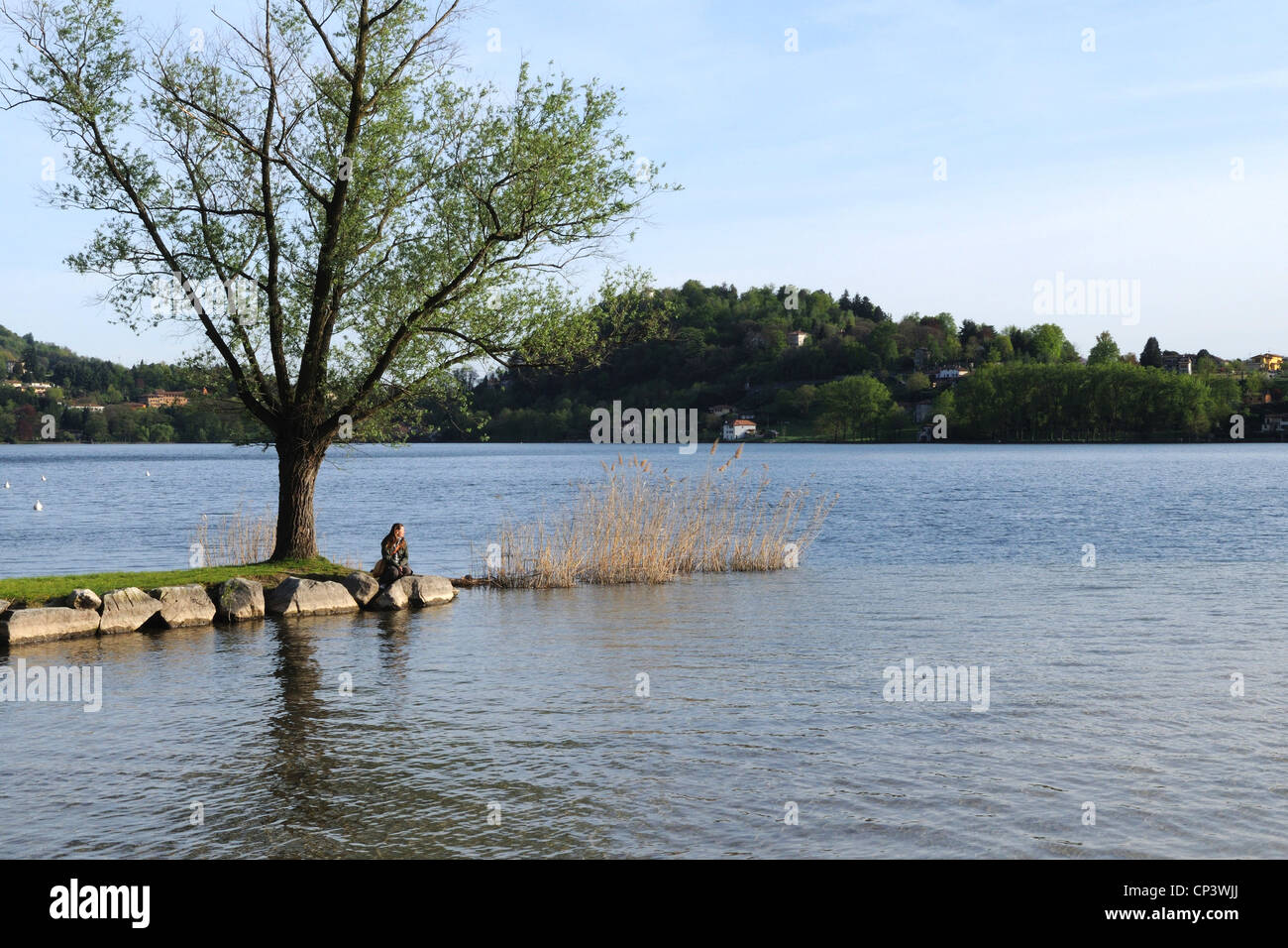 girl on the lake of Orta watching the sunset Stock Photo - Alamy