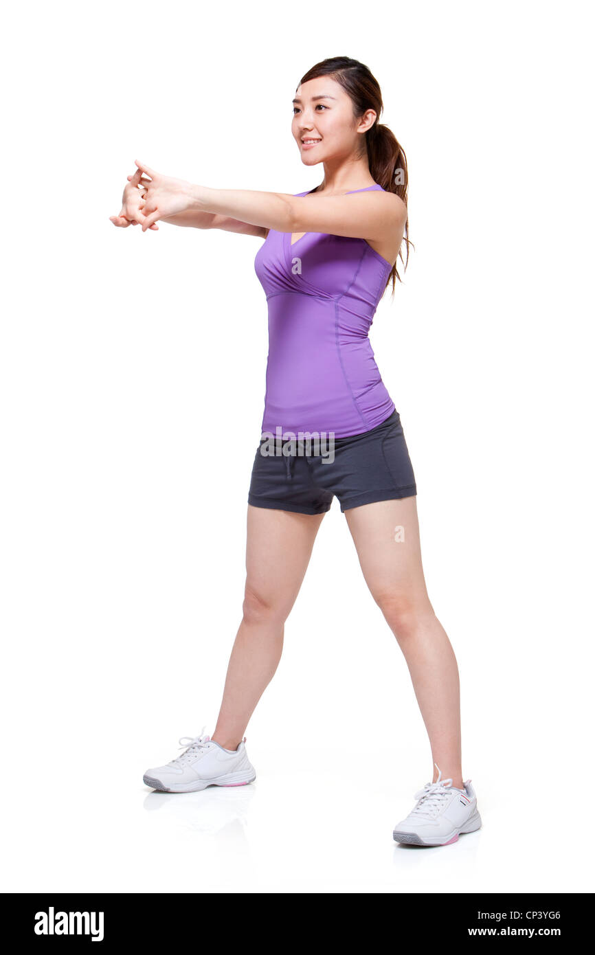 Young woman stretching Stock Photo - Alamy