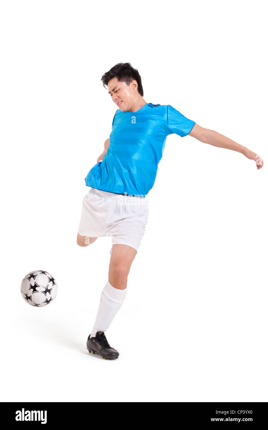 Soccer player kicking Stock Photo - Alamy