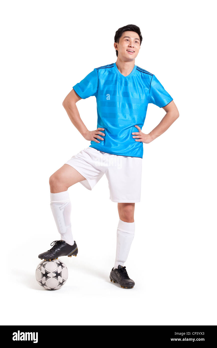 Soccer player with hands on hips stepping on the ball Stock Photo - Alamy