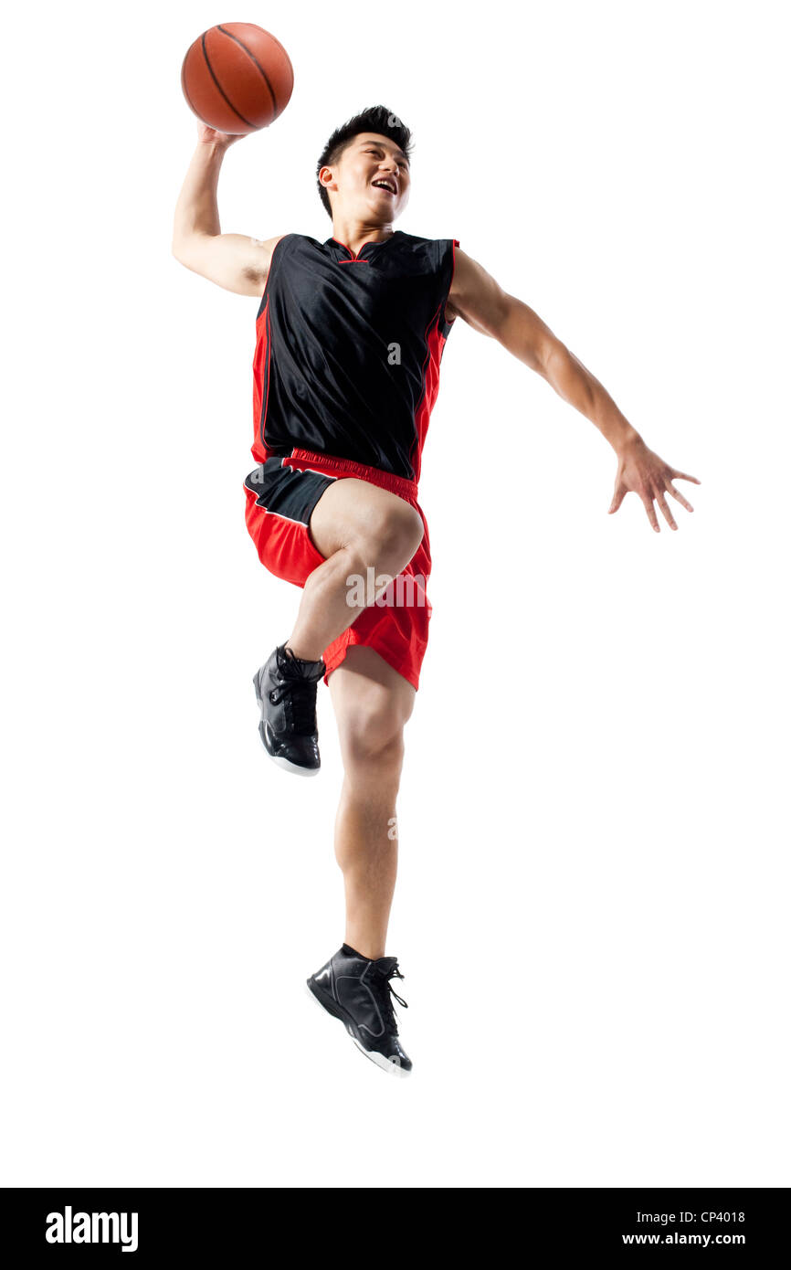 Man jumping to shoot basketball Stock Photo - Alamy