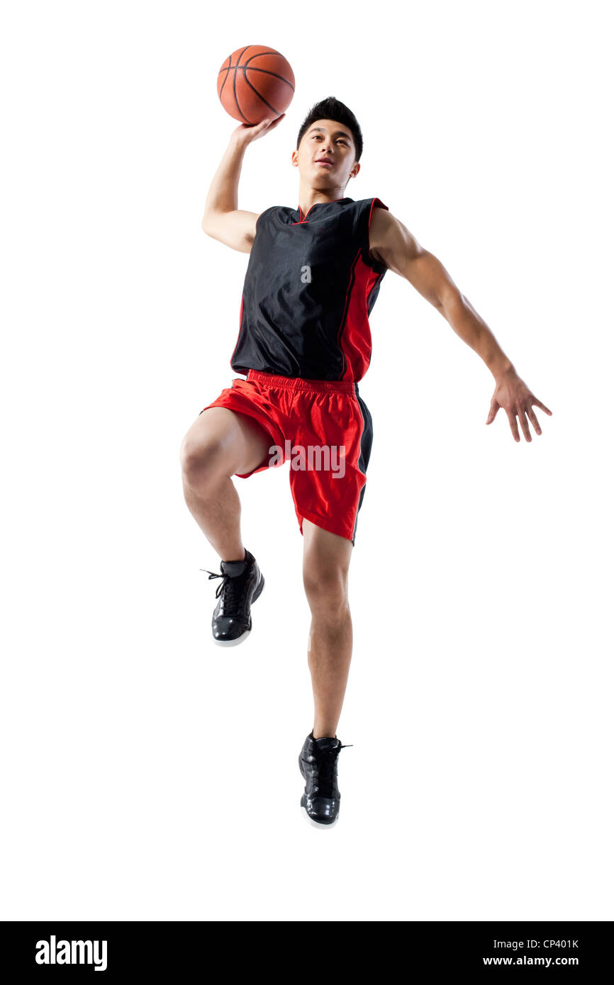 Man jumping to shoot basketball Stock Photo - Alamy
