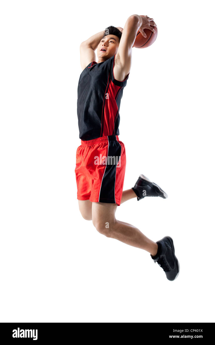 Man jumping to shoot basketball Stock Photo - Alamy