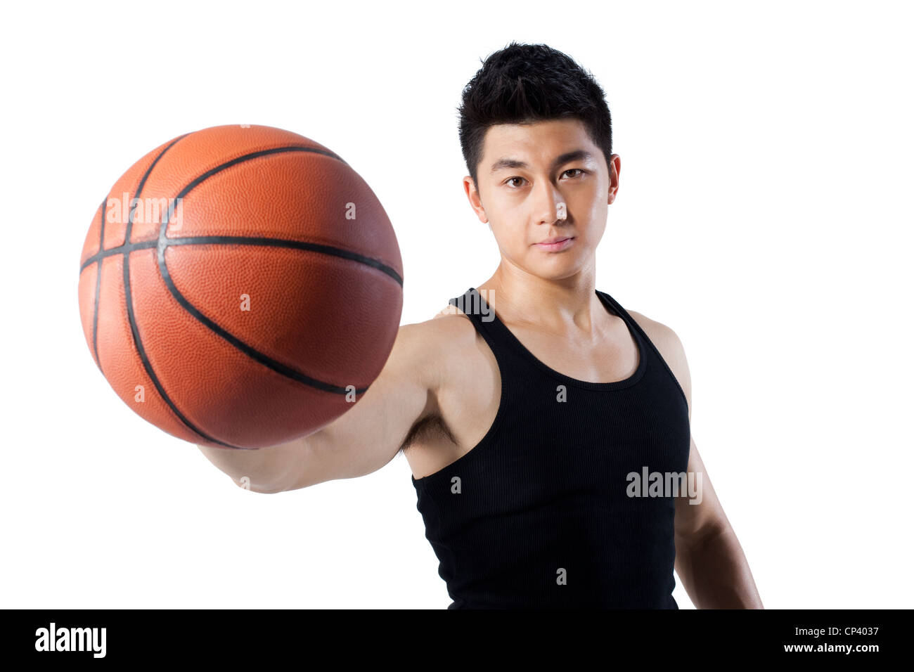 Man holding a basketball with one hand Stock Photo - Alamy