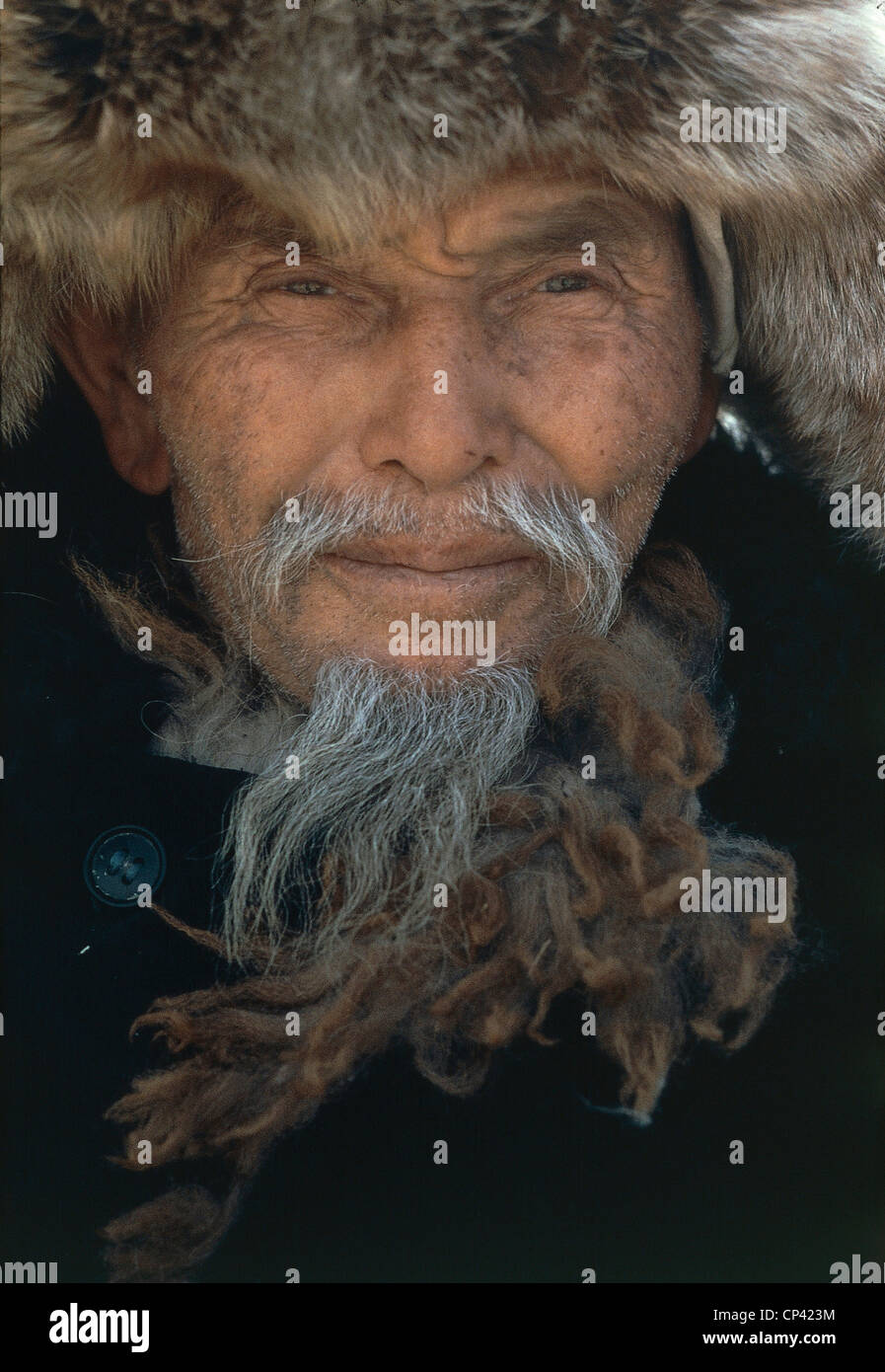 China - Sinkiang. Men in hats with fur Stock Photo - Alamy