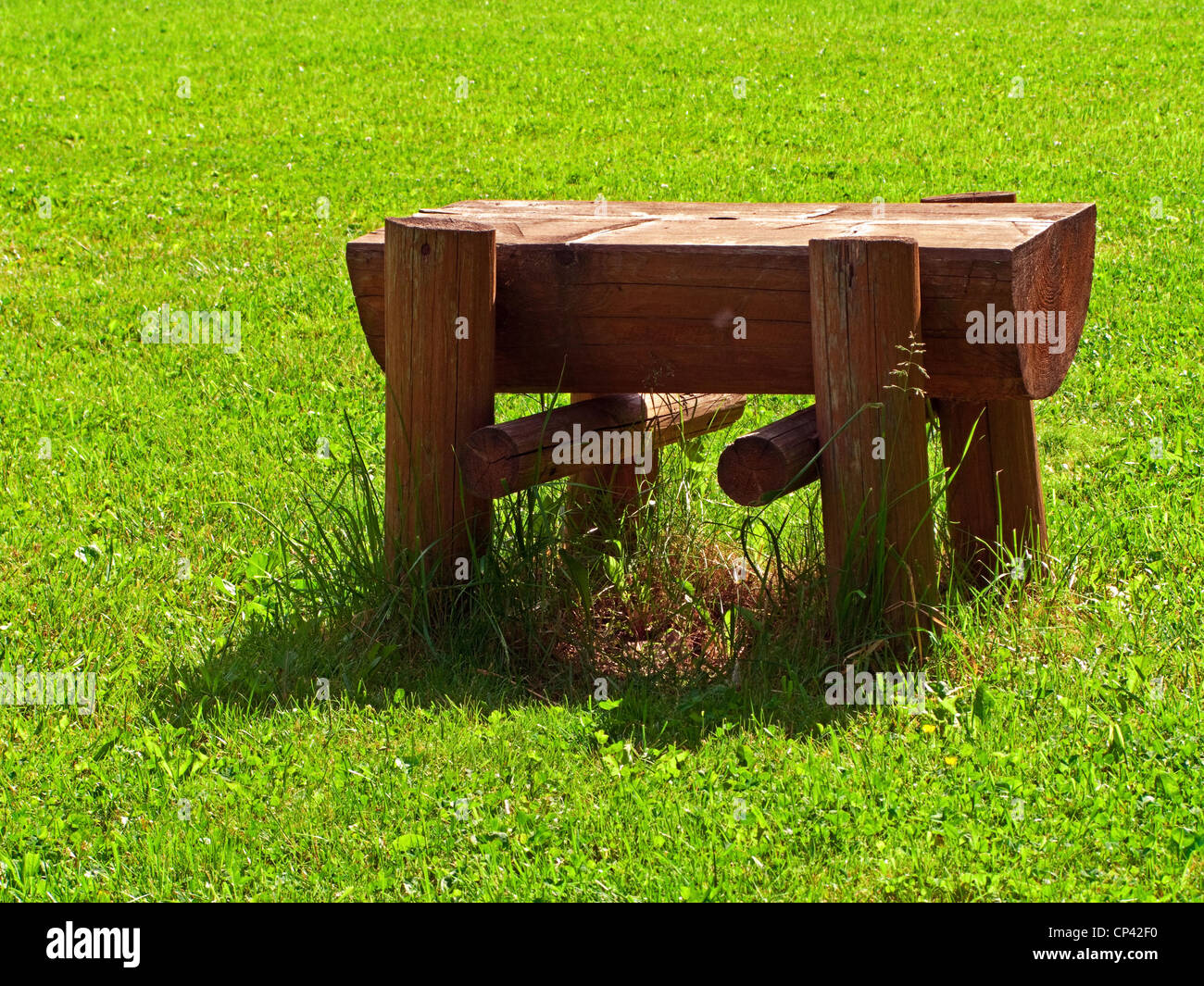 Wood bench on a grass meadow Stock Photo - Alamy