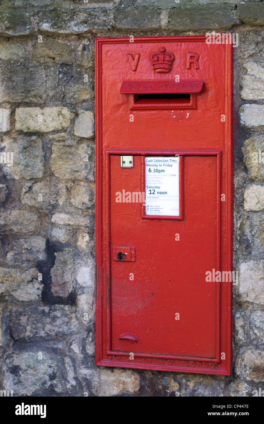 An old red letter box embedded into a stone wall Stock Photo - Alamy