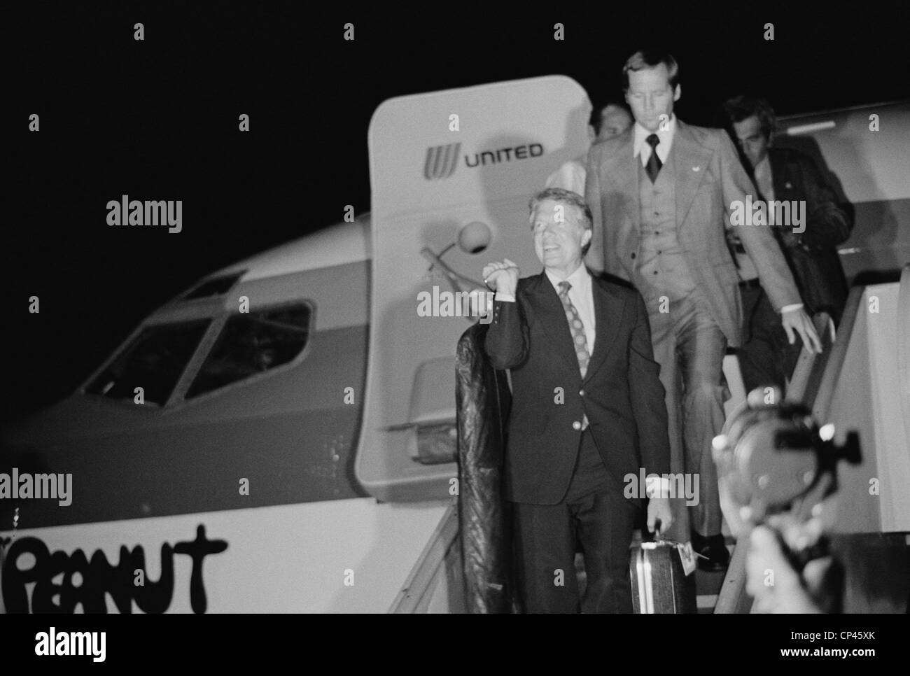 Presidential candidate Jimmy Carter carrying his own luggage as he ...