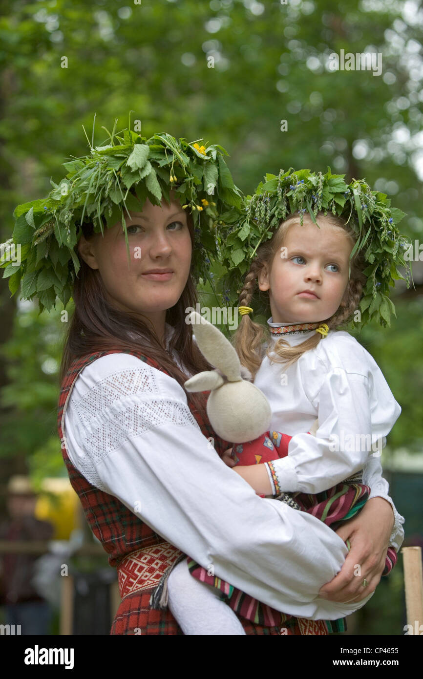 Latvia - Folk festival. Woman and girl in traditional costume with a ...