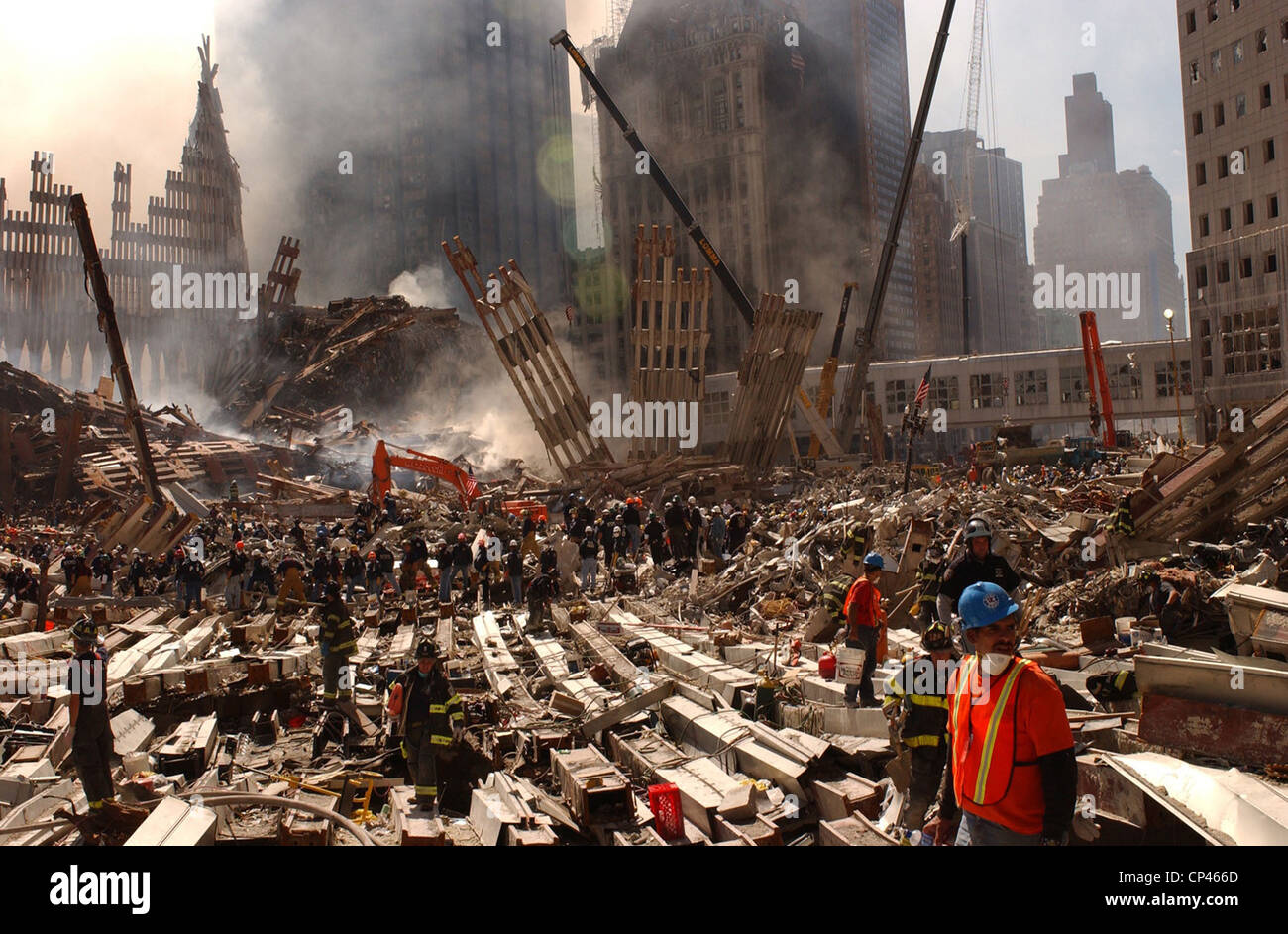 Rescue workers and firefighters in the wreckage at the World Trade ...