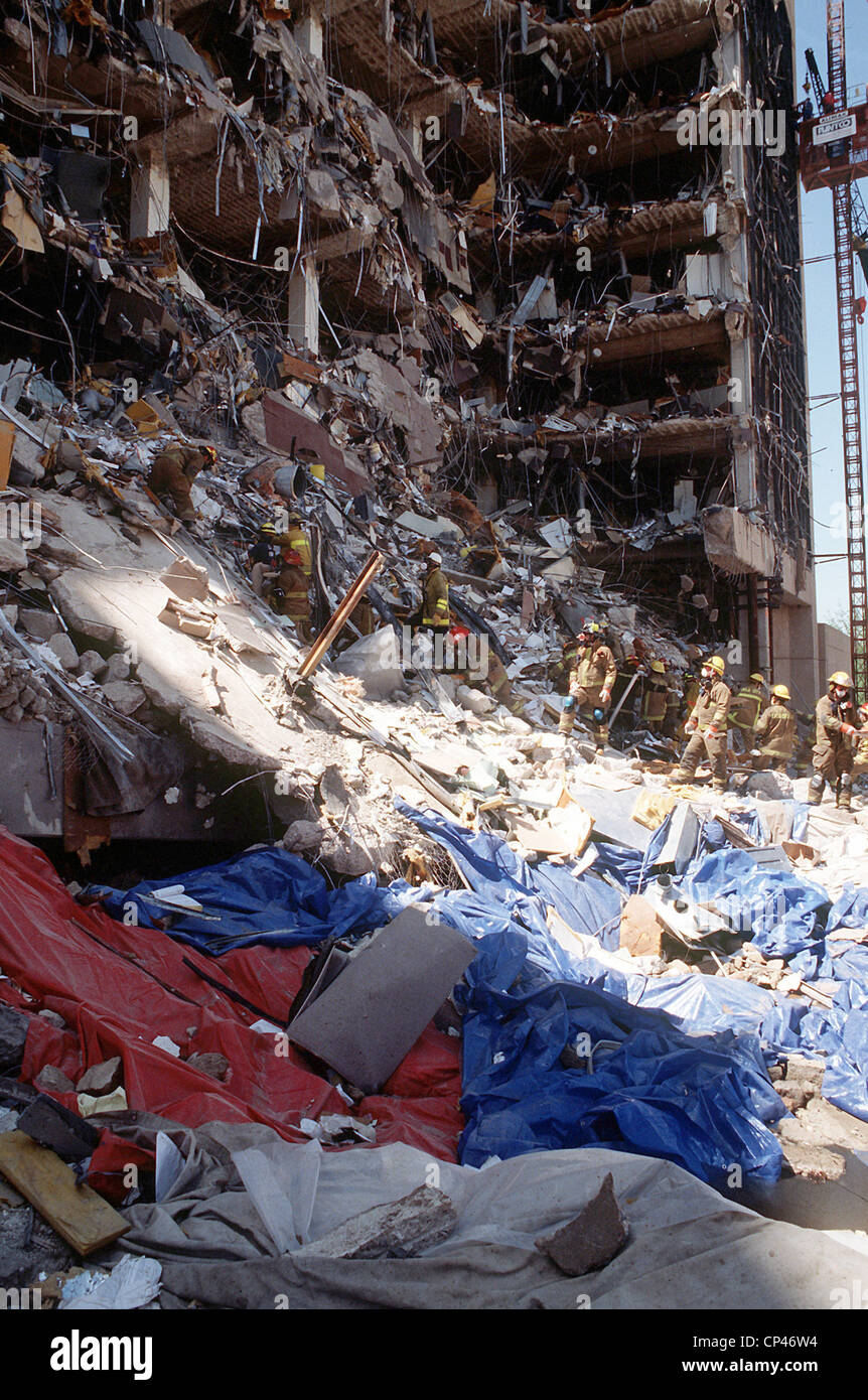 Oklahoma City firefighters form a line to remove rubble from the ...
