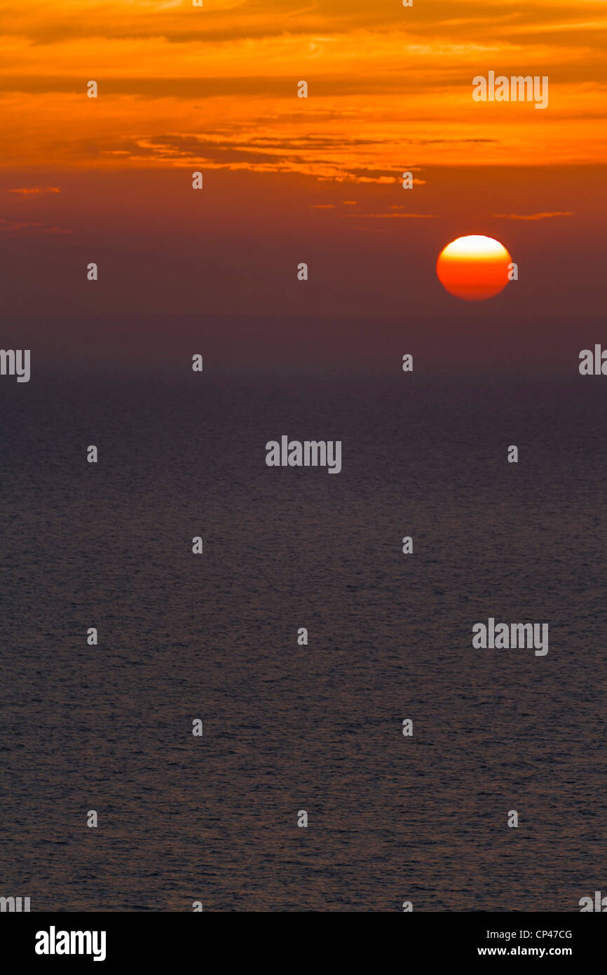 Sun setting into Aegean Sea Stock Photo - Alamy