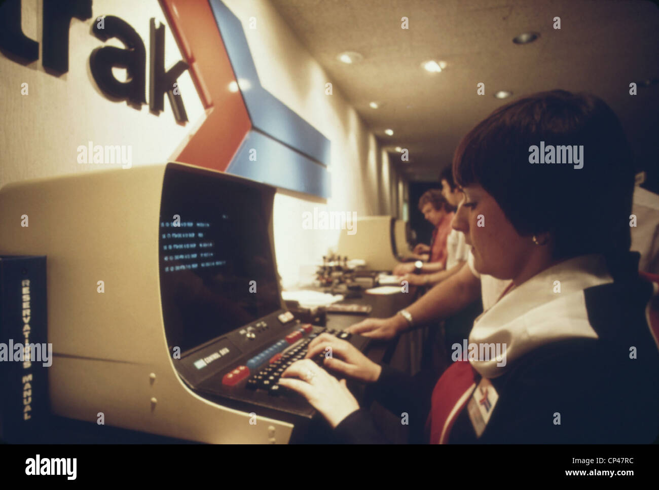 An AMTRAK worker at a computer terminal gets information on available ...