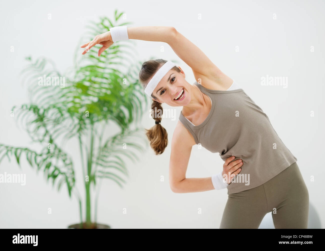 Happy slim woman making stretching exercises Stock Photo - Alamy