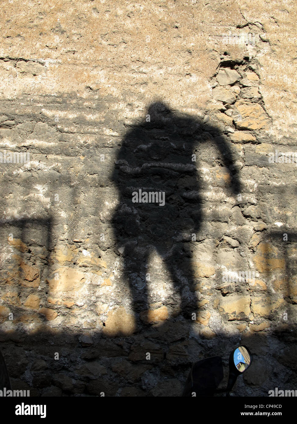 shadow of man standing by fence on wall Stock Photo - Alamy