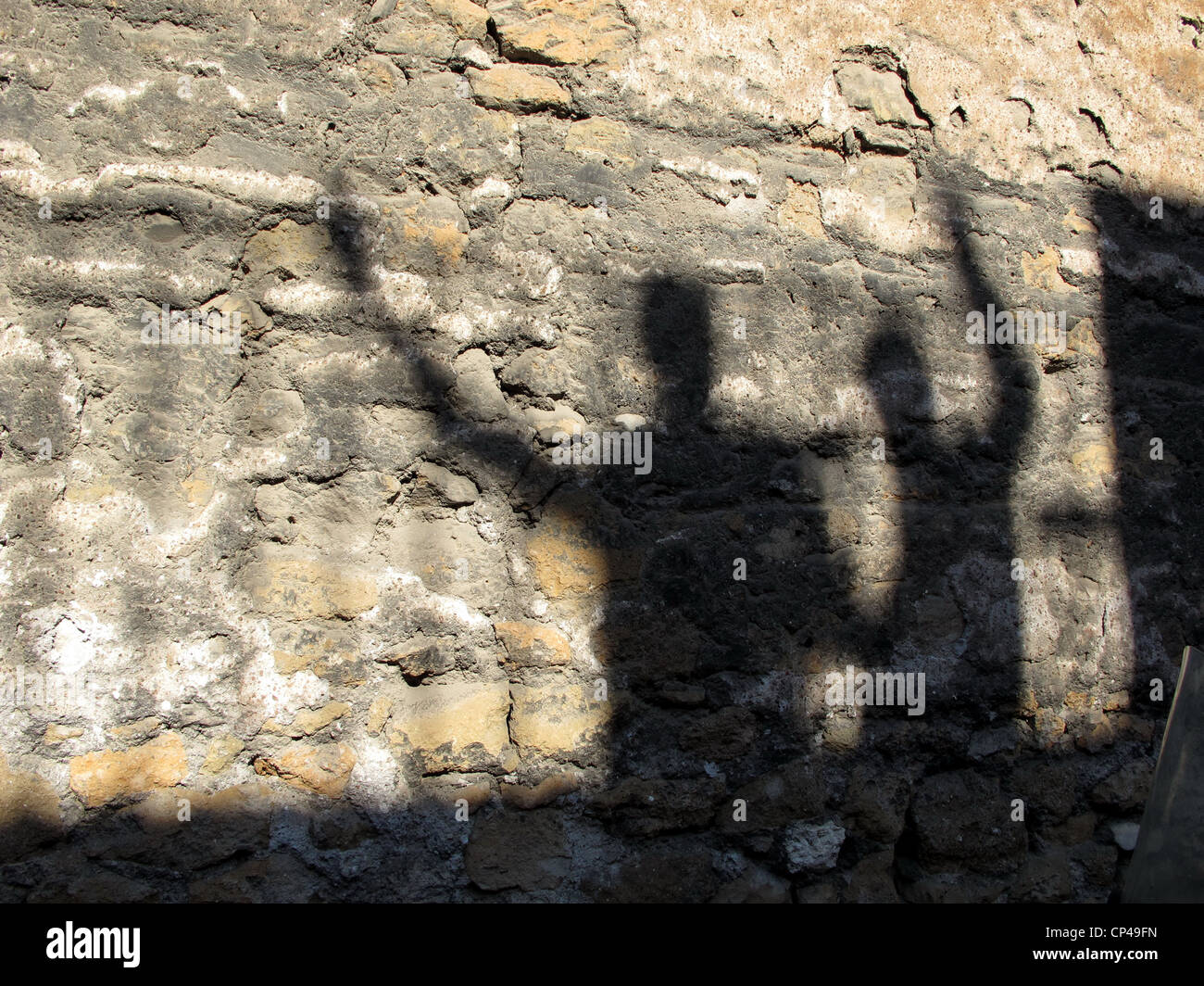 shadow of two people standing by fence on wall Stock Photo - Alamy