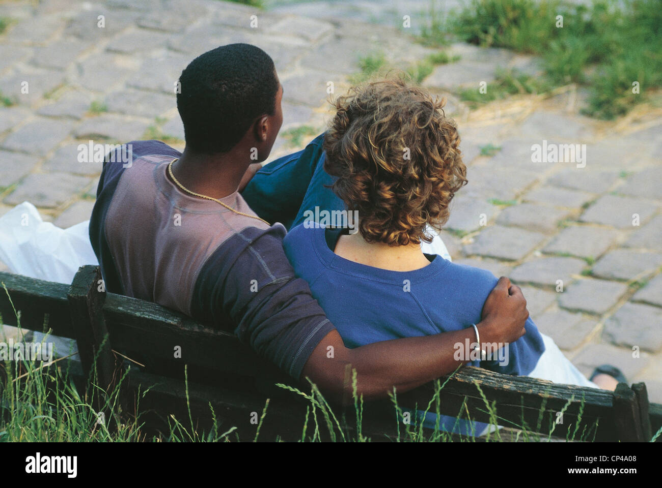 Germany - Heidelberg. Mixed couple sitting on a bench Stock Photo - Alamy