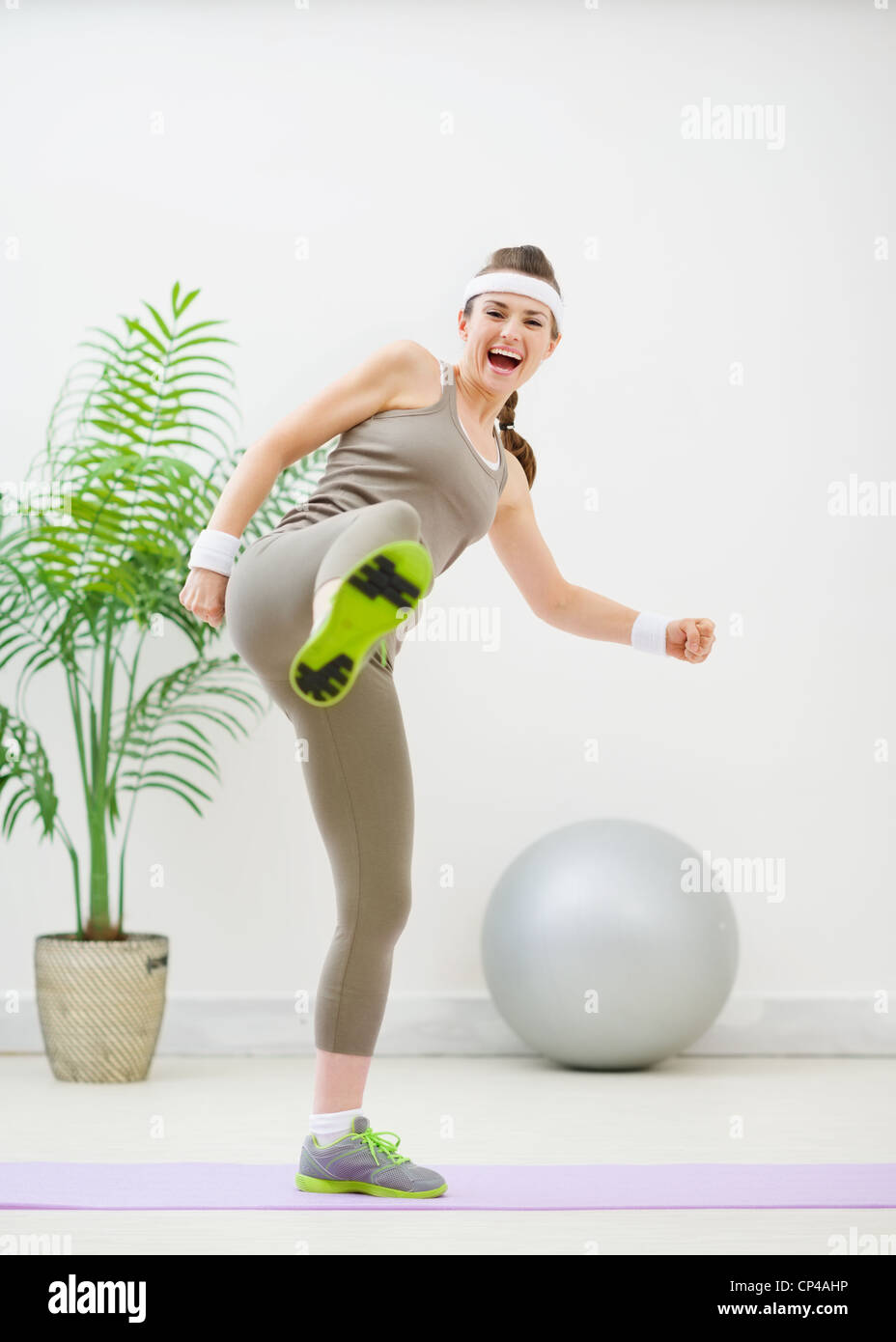 Fitness woman in sportswear kicking Stock Photo - Alamy