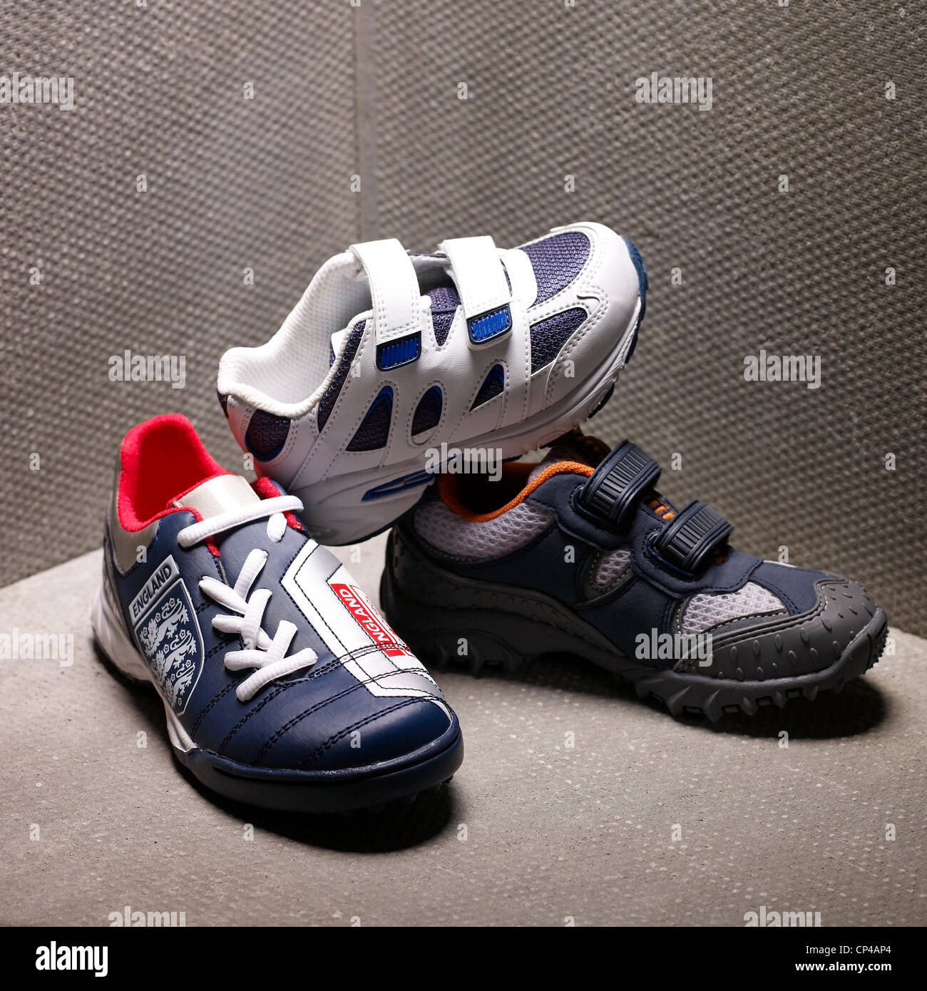 A still life shot of three childrens shoes/sneakers/trainers Stock ...