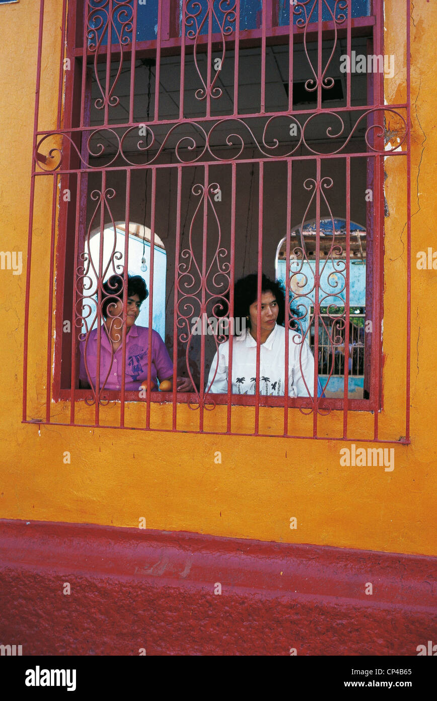 Venezuela - State Zulia - Maracaibo. Women facing a window of a ...