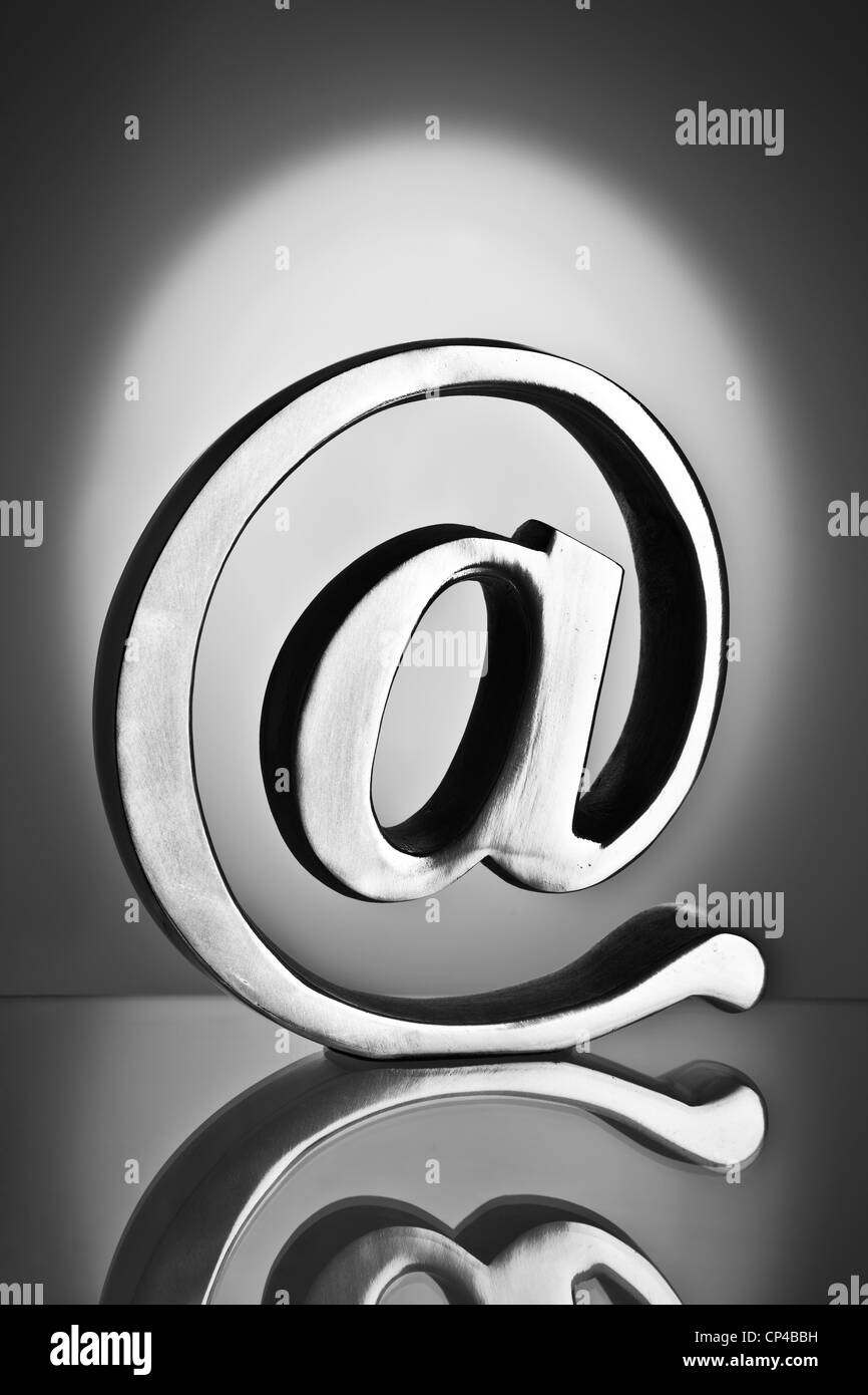 At symbol paperweight on a reflective surface Stock Photo - Alamy