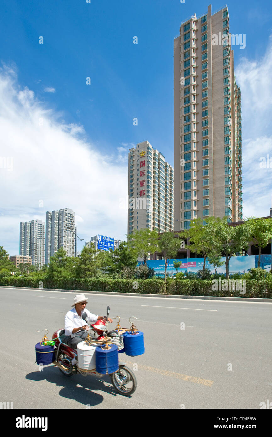 A tricycle carrying goods travelling along one of the main roads in ...