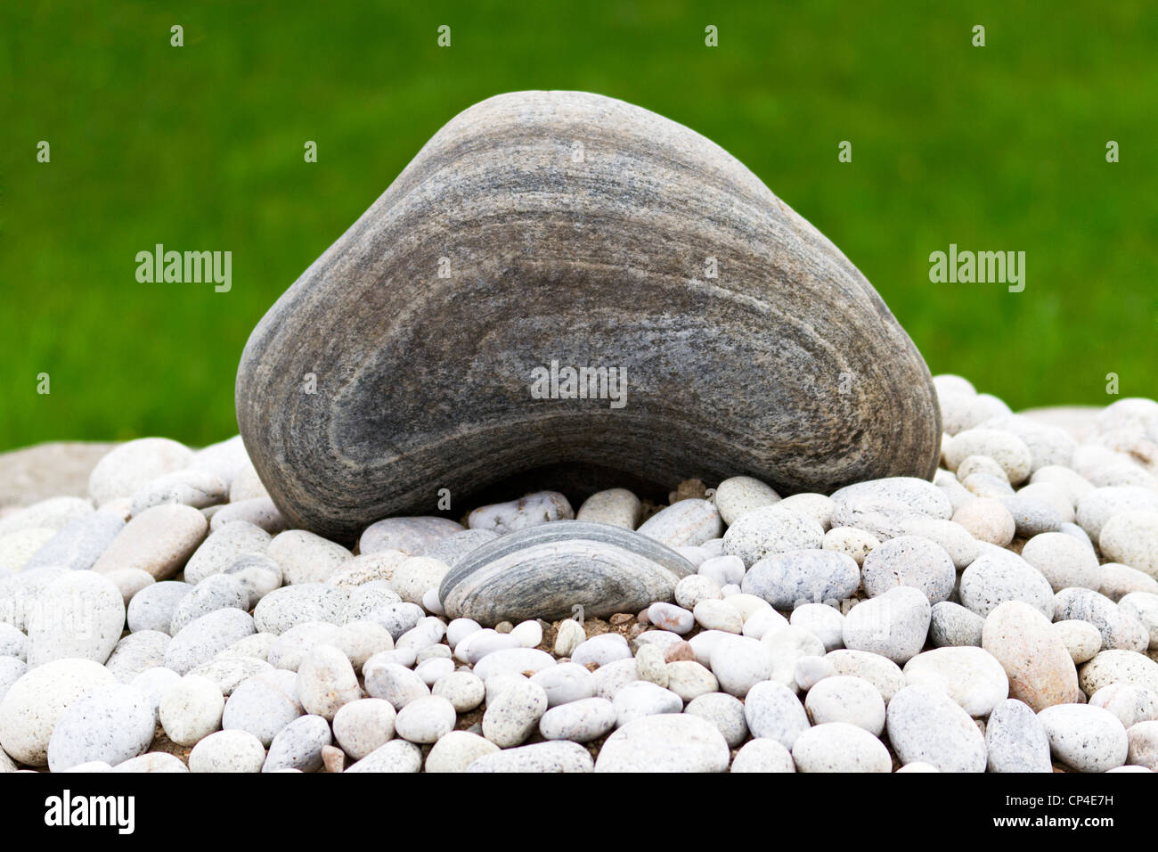 Two natural rock elements, one large and one small, of Zen garden are ...