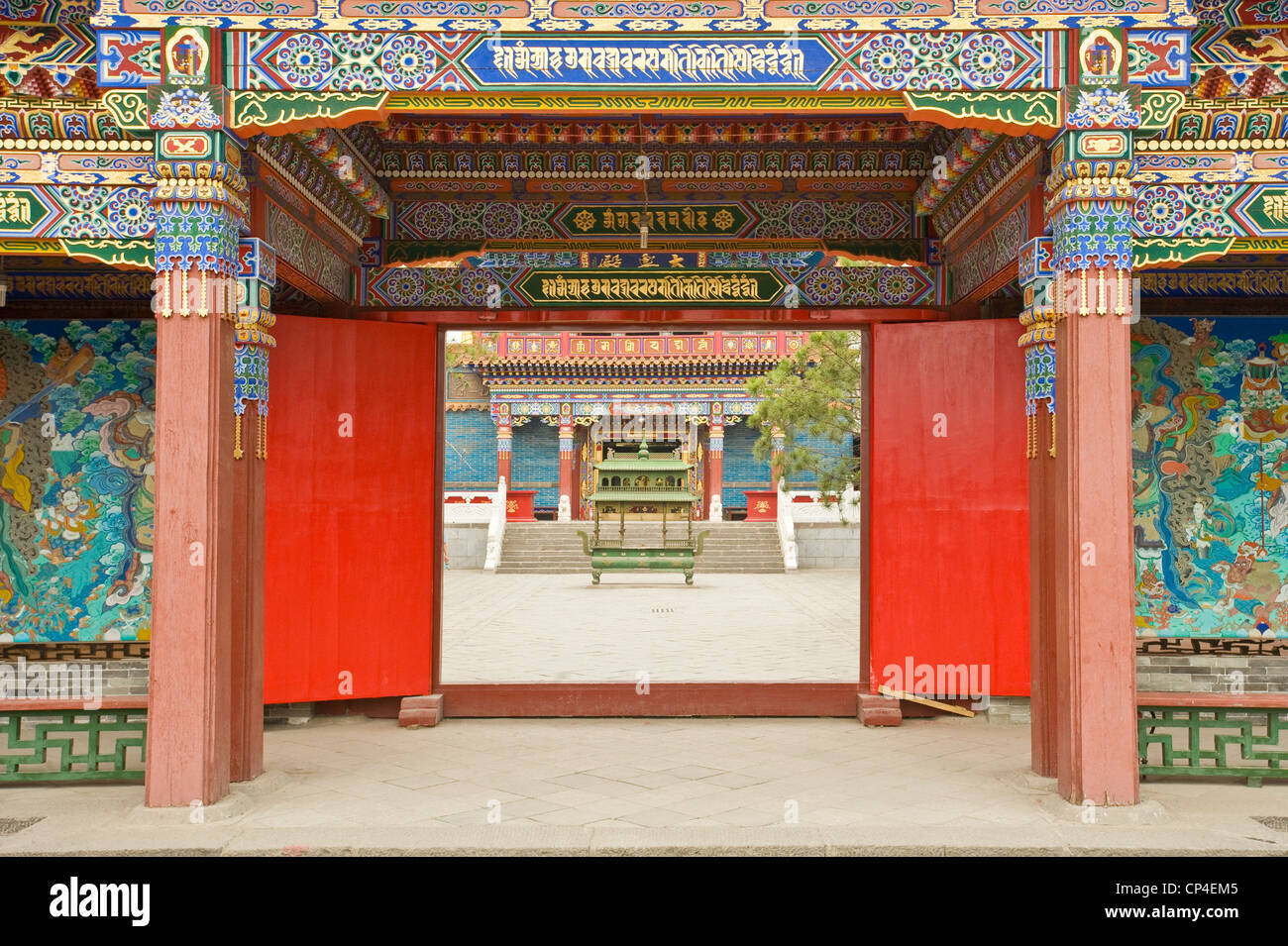 A colourful and intricately painted doorway at the Dazhao Temple in ...