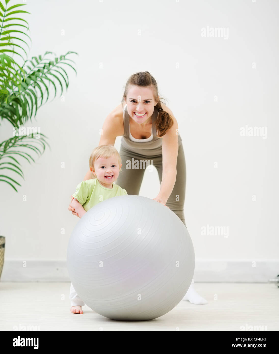 Portrait of mother and baby playing with fitness ball Stock Photo - Alamy