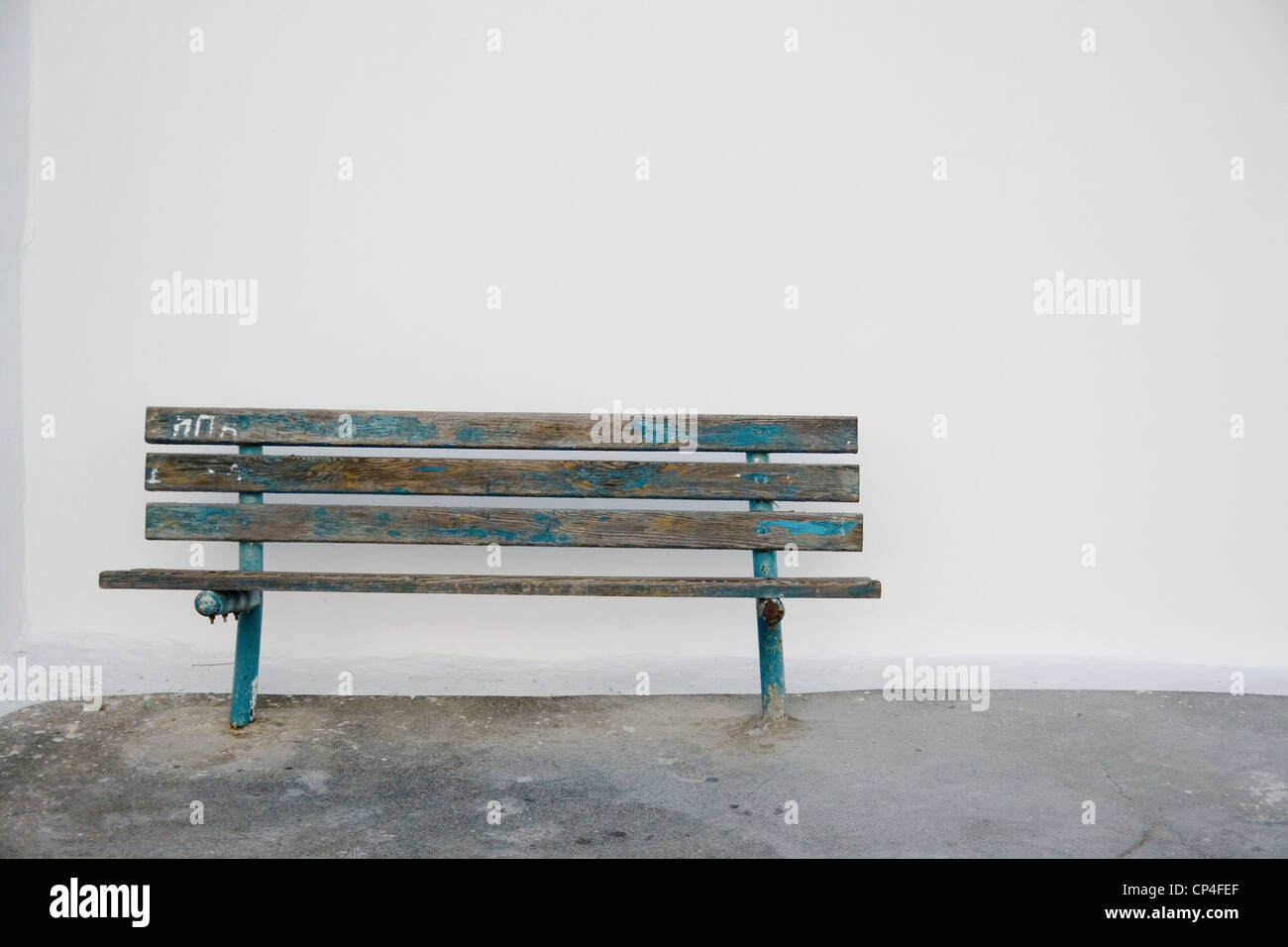 Wooden bench against white wall Stock Photo - Alamy