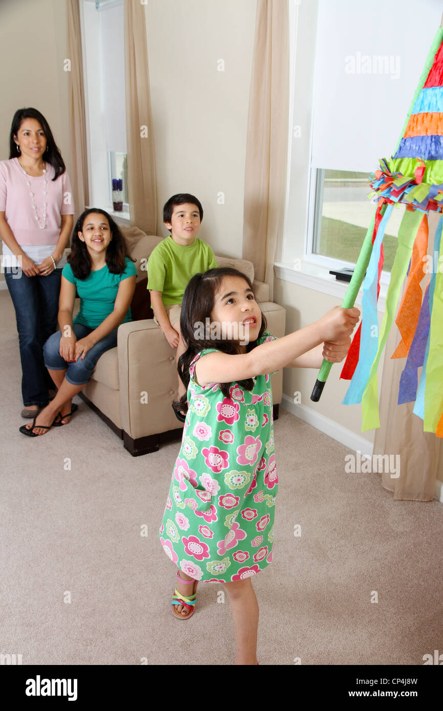 Kids hitting a piñata at birthday party Stock Photo - Alamy