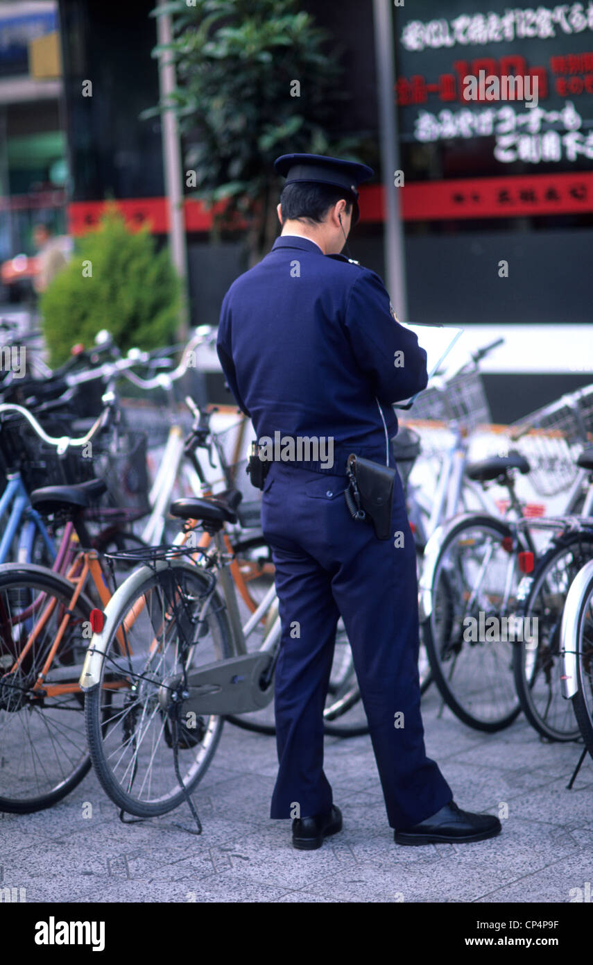 Japan, Tokyo, Asakusa, a police man books a bike for not being ...