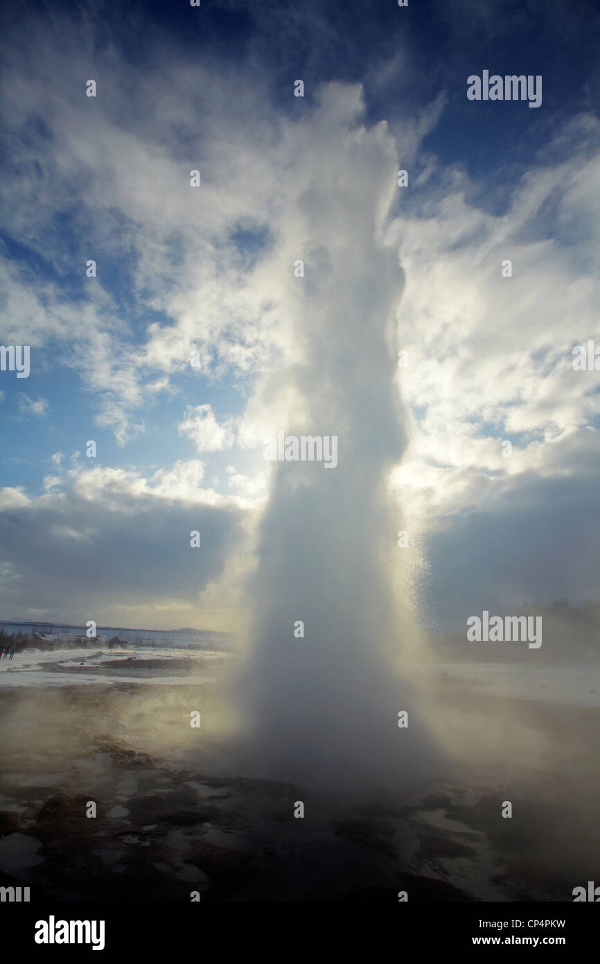 Strokkur fountain geyser exploding into the air and backlit by the sun ...